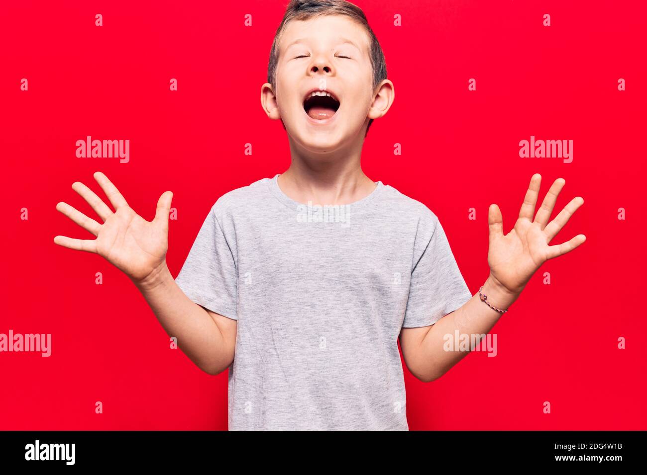 Cute blond kid wearing casual clothes celebrating mad and crazy for ...