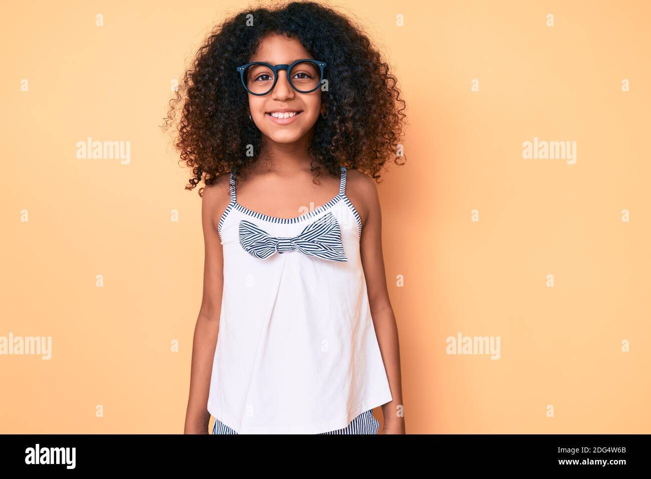 African american child with curly hair wearing casual clothes and ...