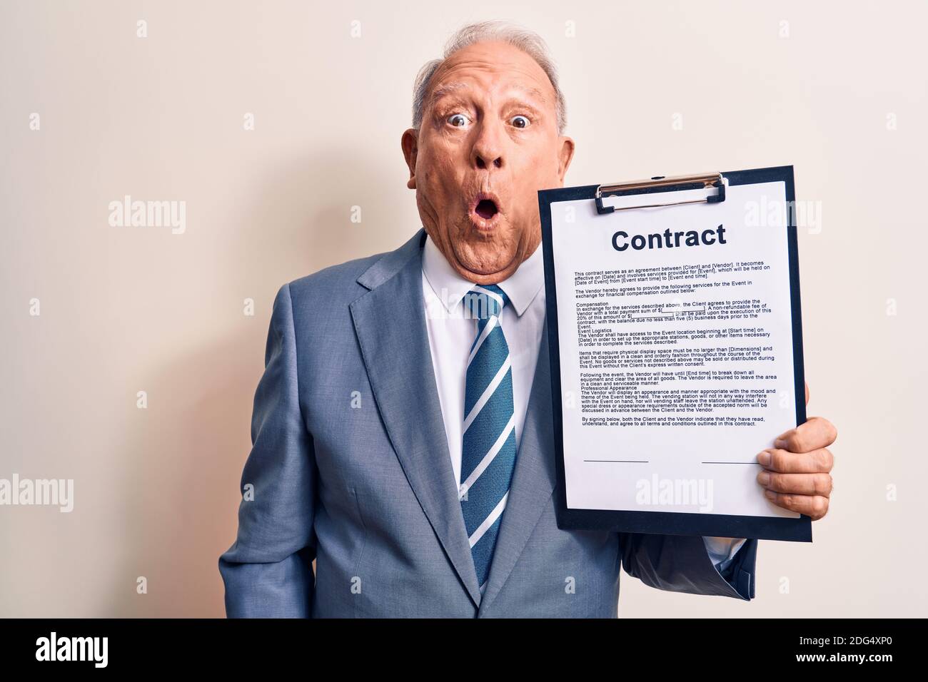 Senior grey-haired businessman wearing suit holding clipboard with ...
