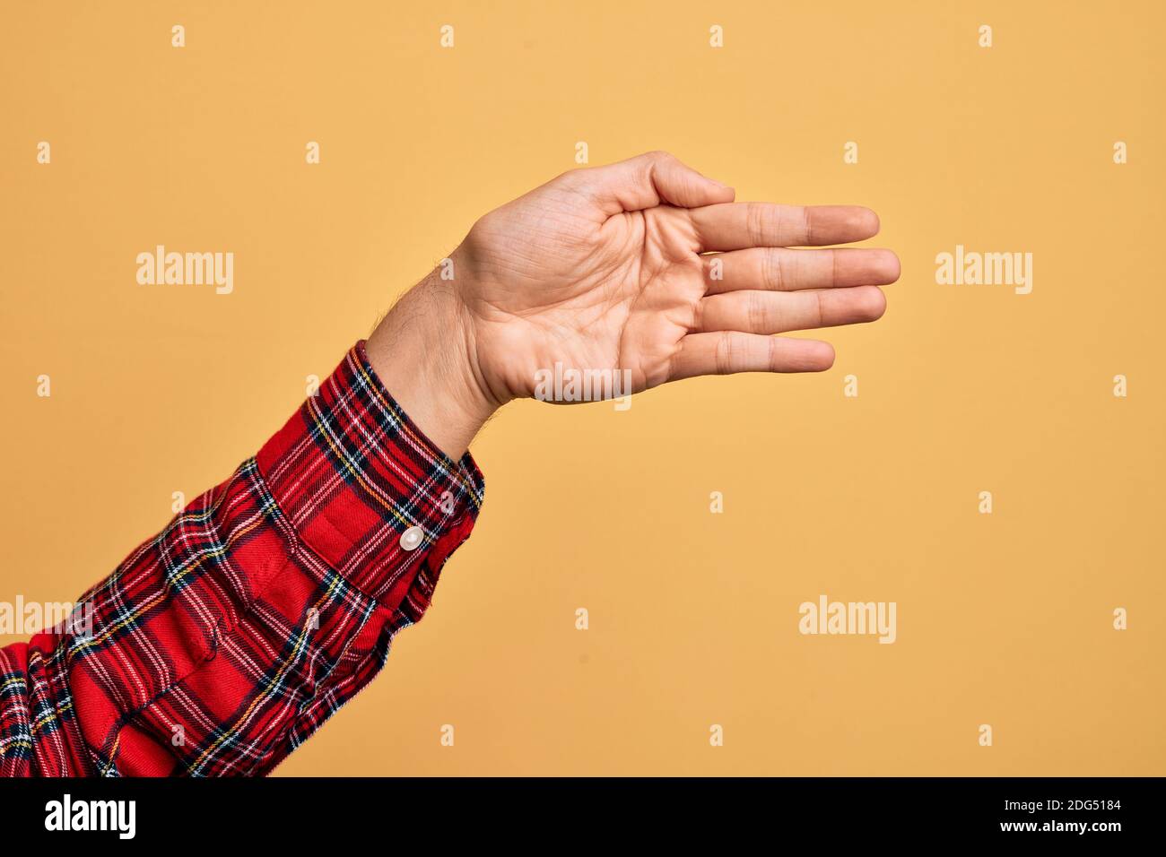 Hand of caucasian young man showing fingers over isolated yellow ...