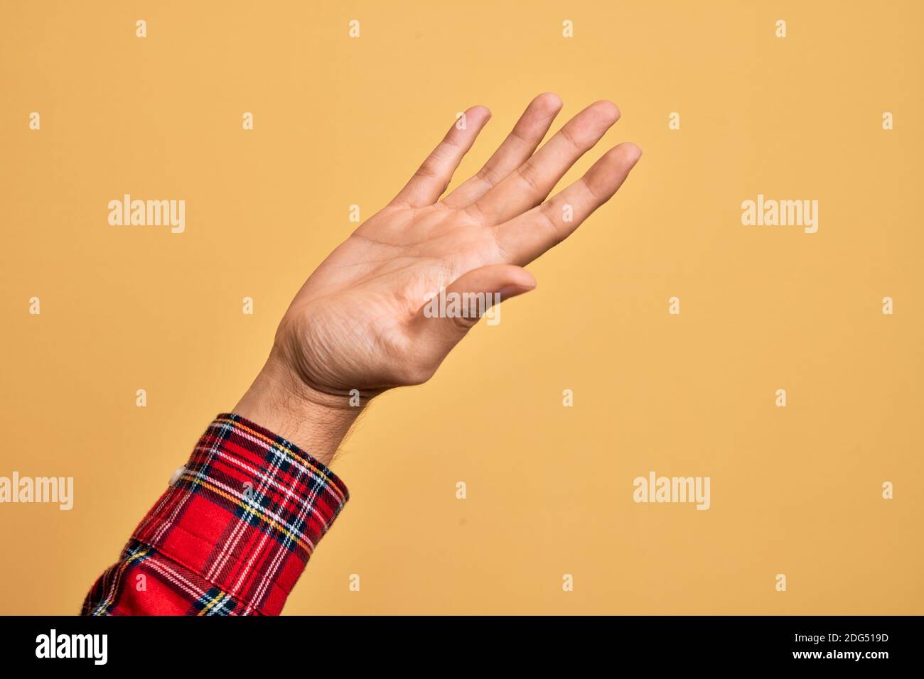 Hand of caucasian young man showing fingers over isolated yellow ...