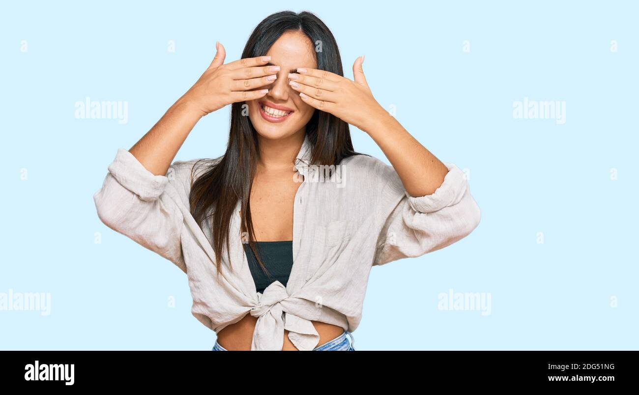 Young Beautiful Hispanic Girl Wearing Casual Clothes Covering Eyes With