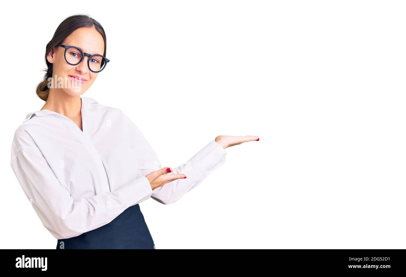 Beautiful brunette young woman wearing professional waitress apron ...