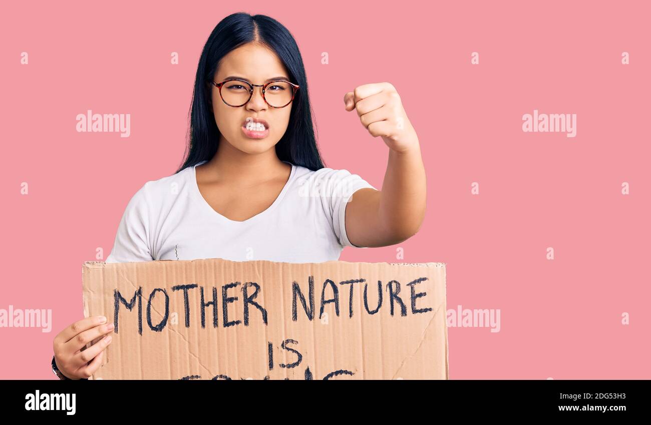 Young beautiful asian girl holding mother nature is crying protest ...