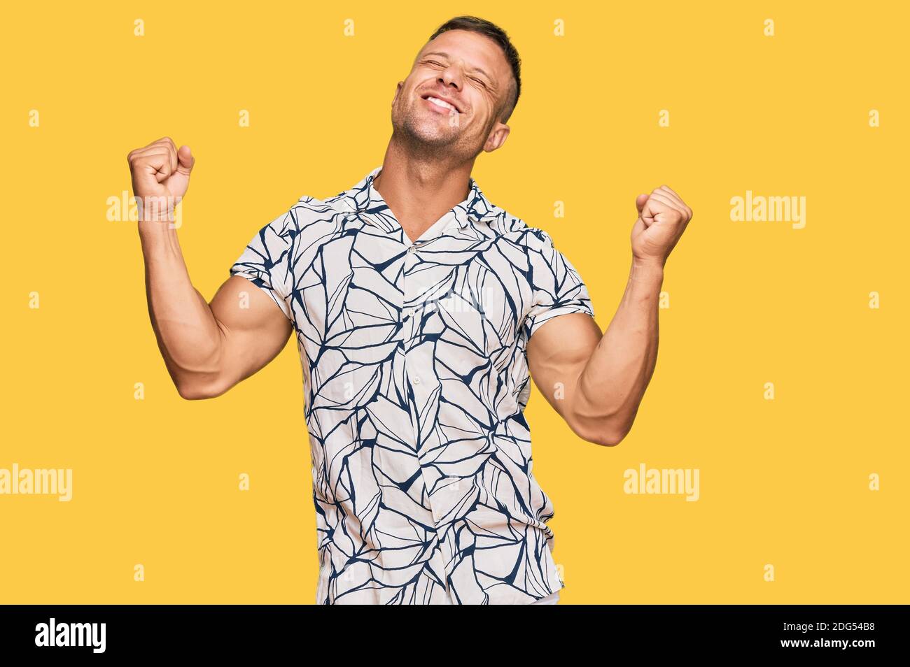 Handsome muscle man wearing casual clothes very happy and excited doing ...