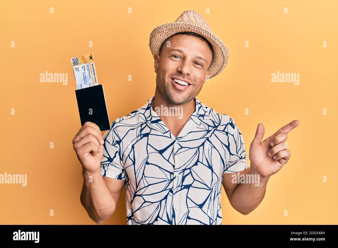 Handsome muscle man holding boarding pass and passport smiling happy ...