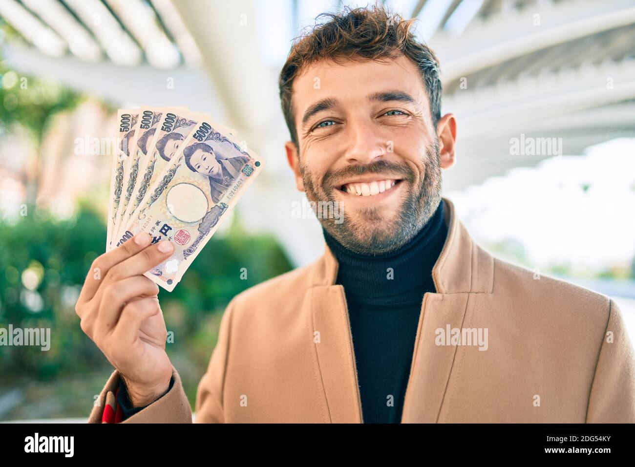 Handsome business man wearing elegant jacket smiling happy outdoors and ...
