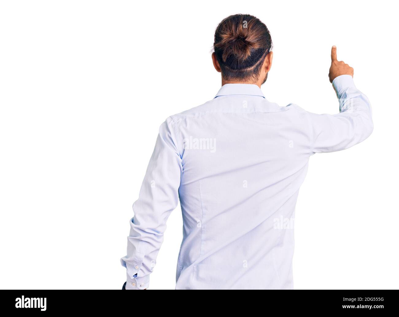 Young handsome man wearing business clothes posing backwards pointing ...