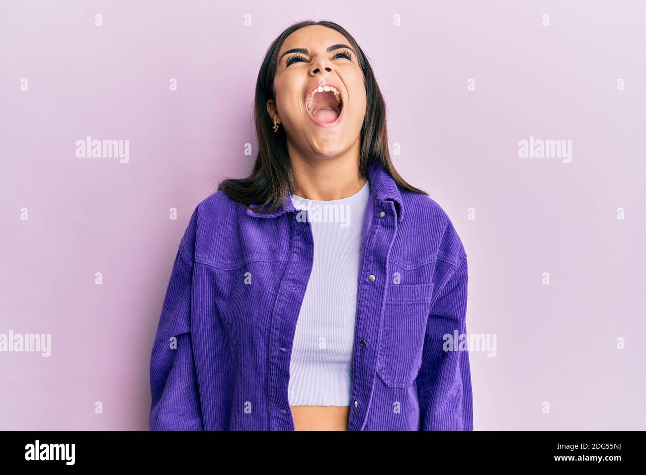 Young brunette woman wearing casual clothes angry and mad screaming ...