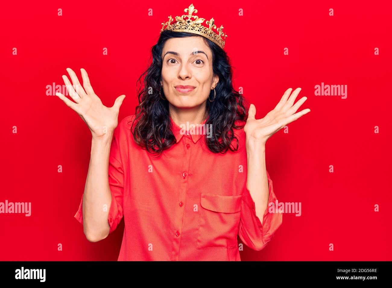 Young beautiful hispanic woman wearing princess crown clueless and ...