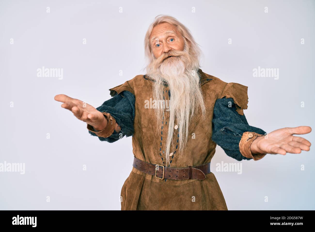 Old senior man with grey hair and long beard wearing viking traditional ...