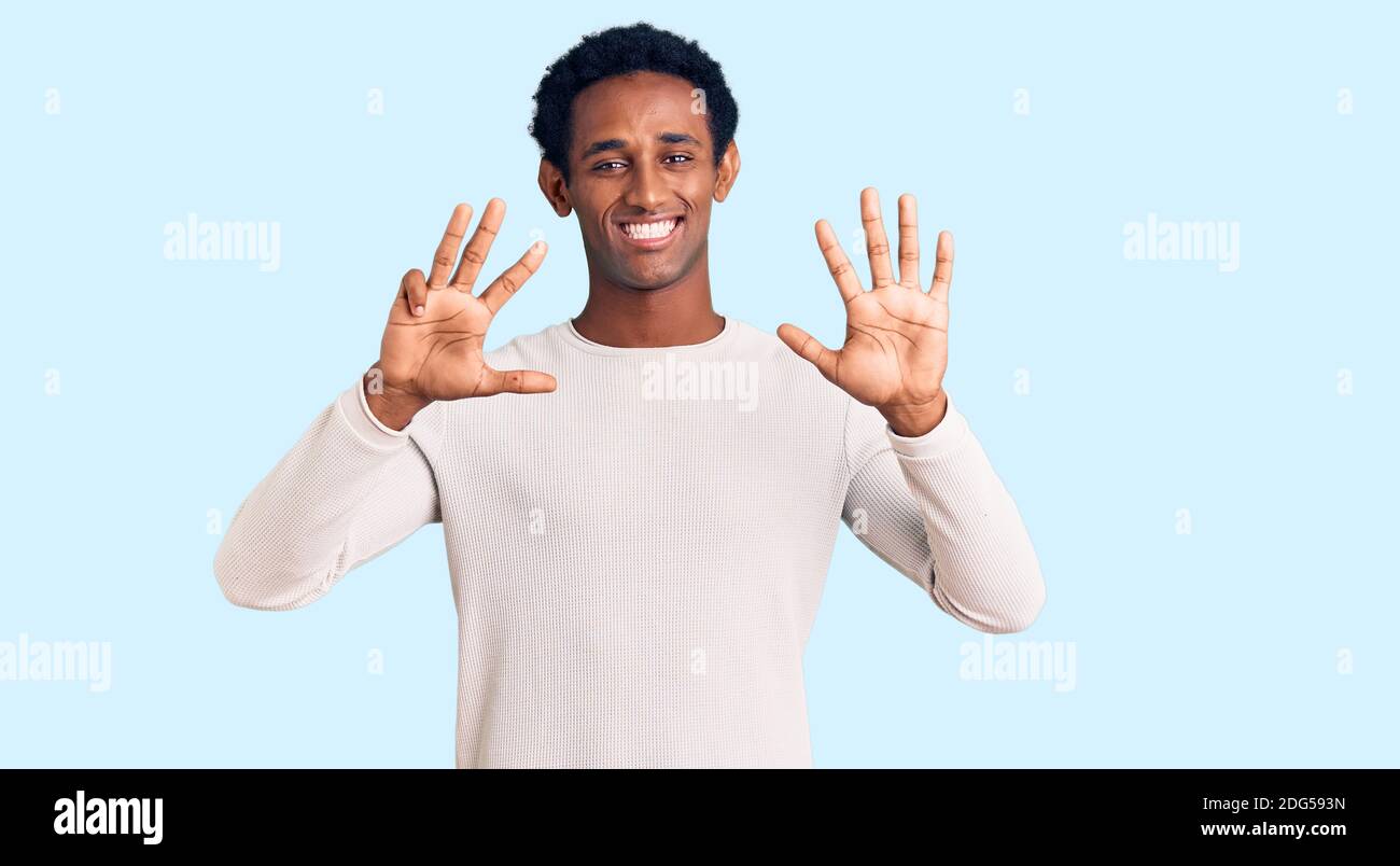 African handsome man wearing casual winter sweater showing and pointing ...