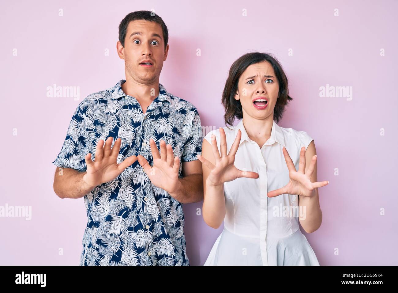 Beautiful couple wearing casual clothes afraid and terrified with fear ...