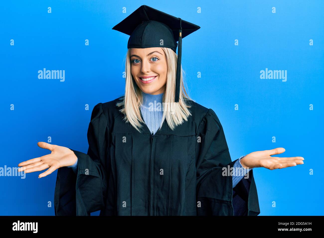 Beautiful blonde woman wearing graduation cap and ceremony robe ...