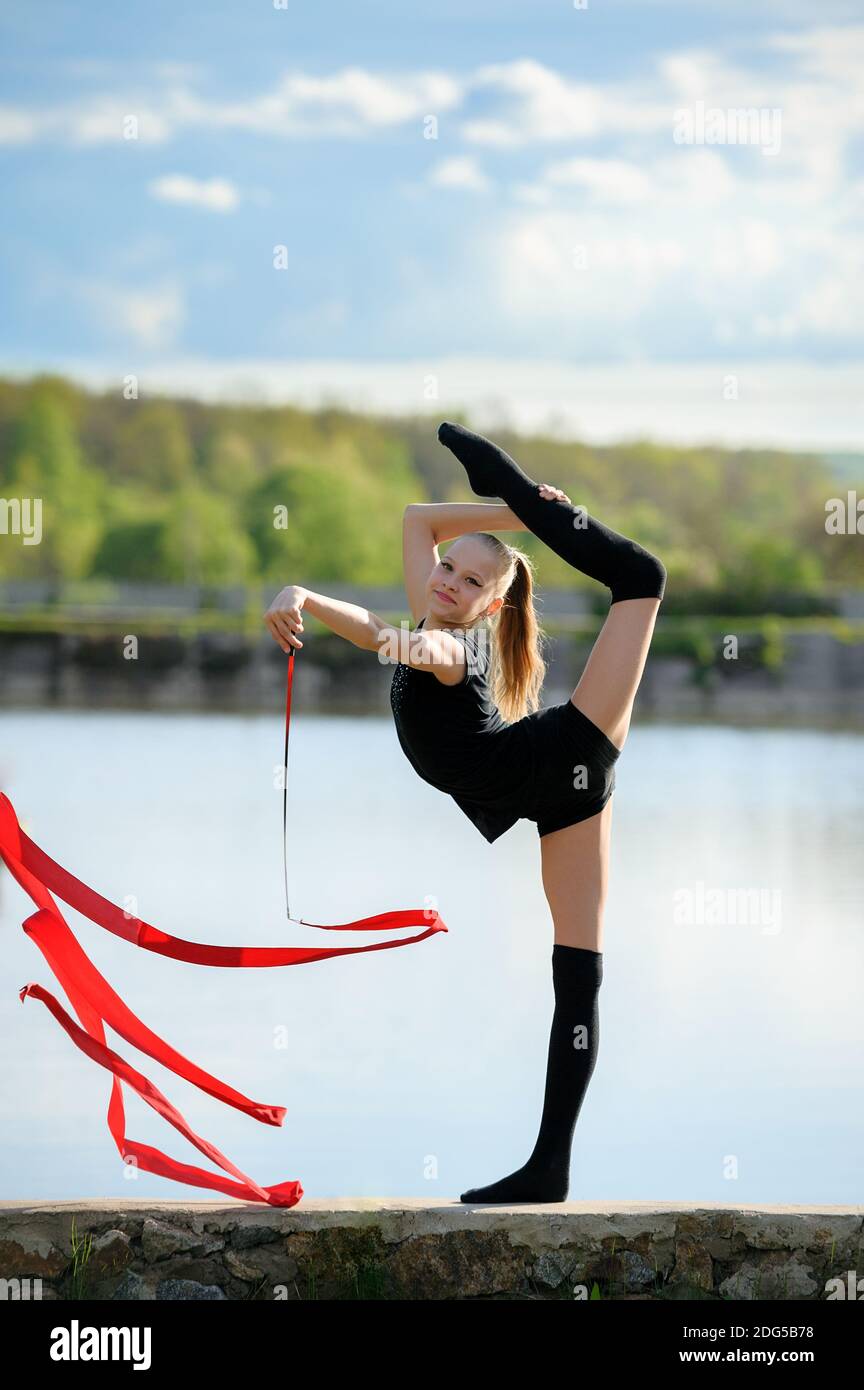 Rhythmic Gymnast in Vertical Split with Ribbon Stock Photo - Alamy