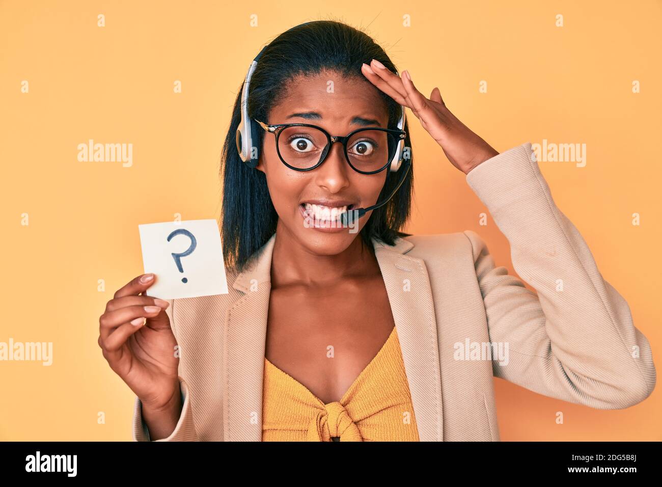 Young african american woman wearing operator headset holding question ...