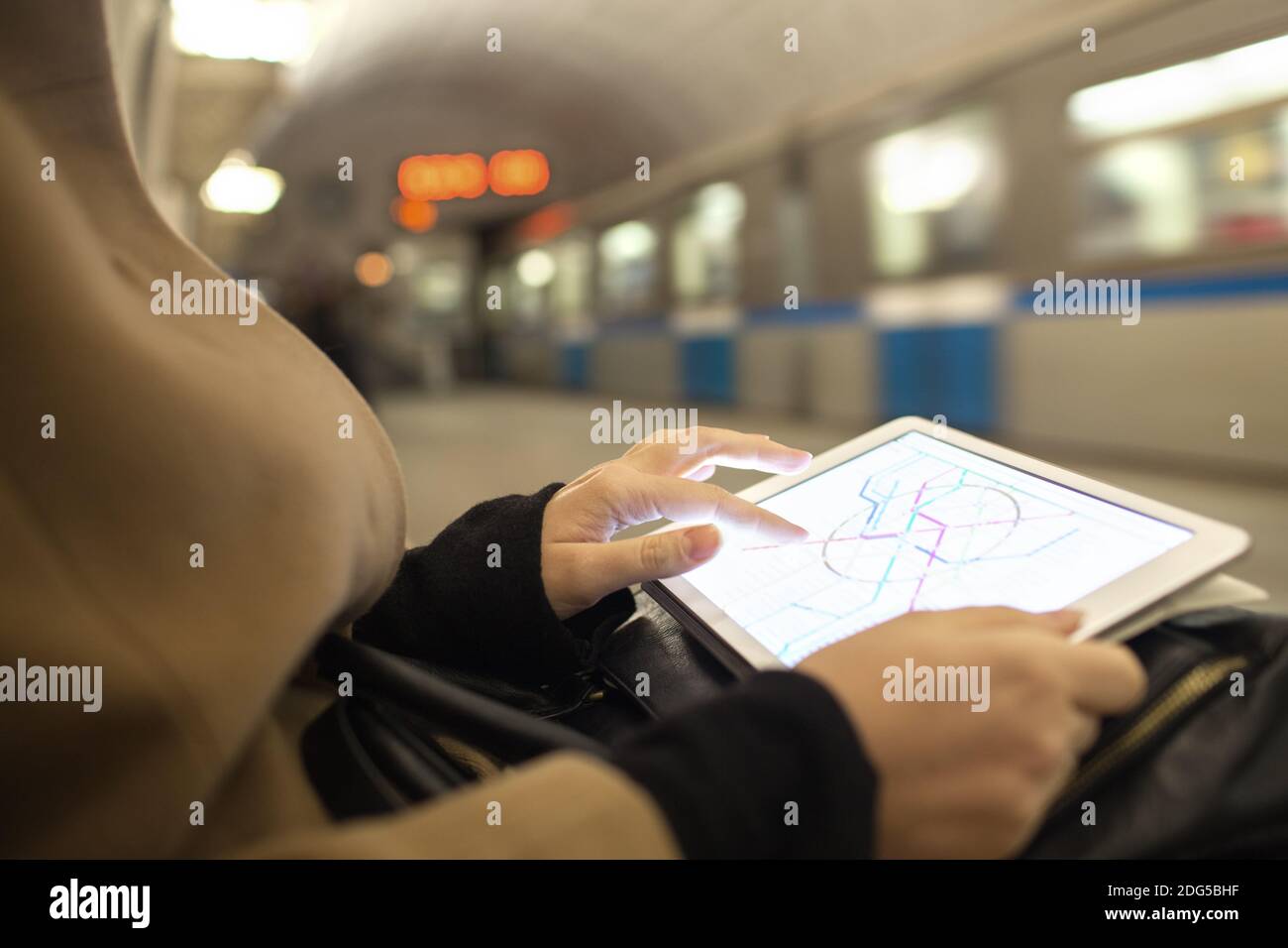 Tablet in female hands showing subway map in underground Stock Photo ...