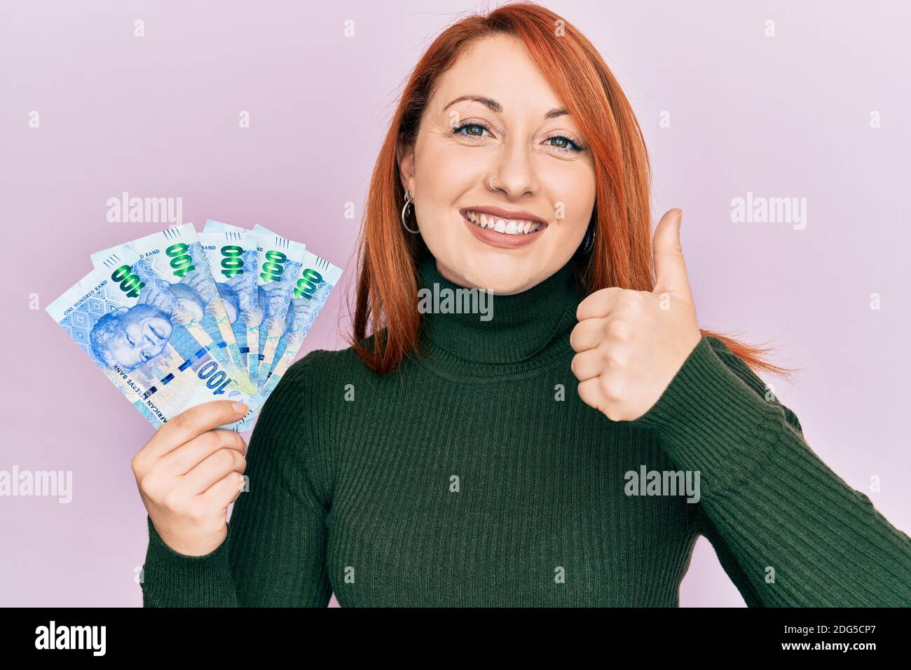 Beautiful redhead woman holding south african 100 rand banknotes ...