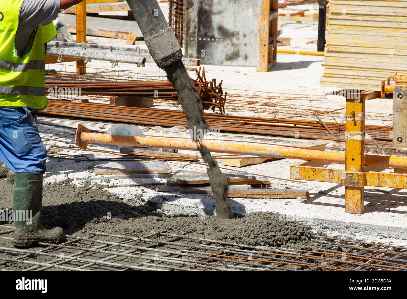 pipe with cement filling the foundation slab of a building under ...