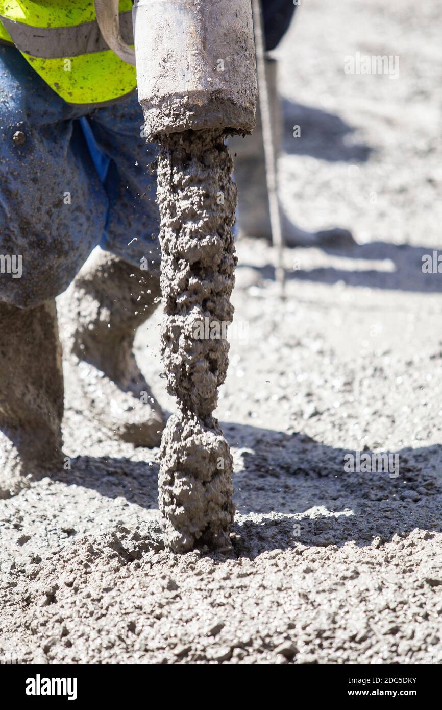 Worker filling the foundation slab of a building under construction ...