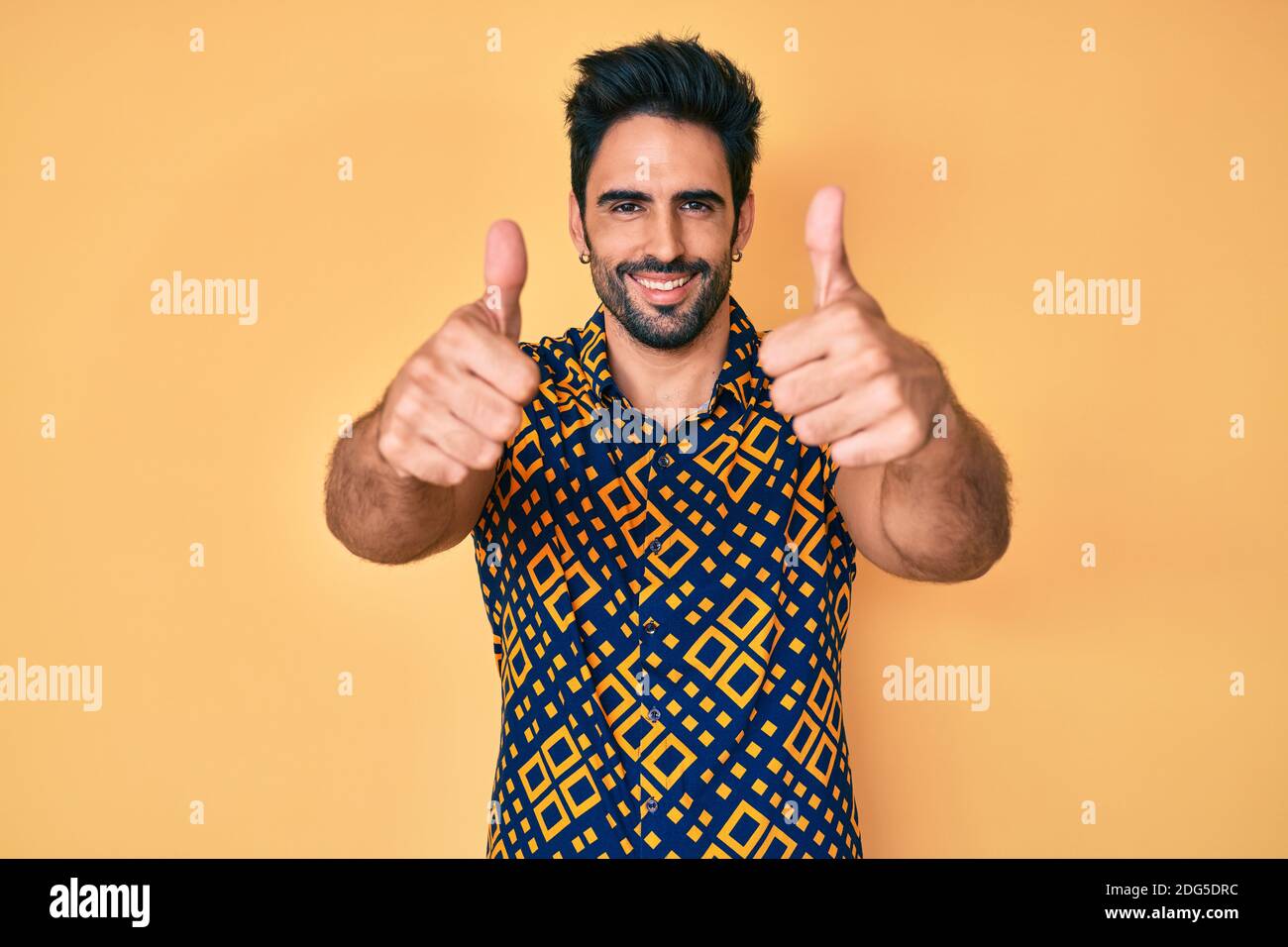 Handsome hispanic man with beard wearing 80s disco style shirt ...