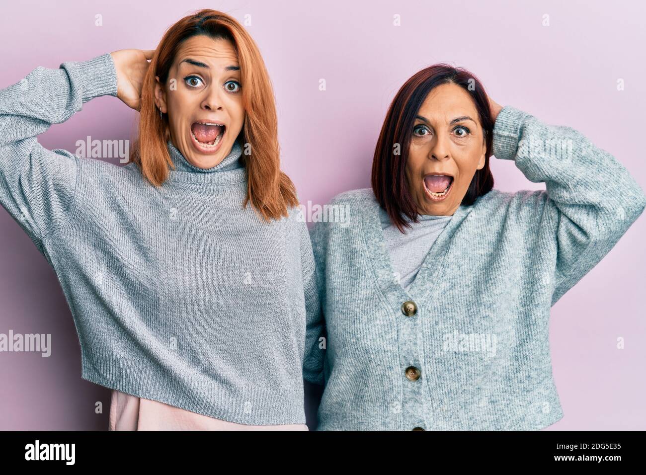 Latin mother and daughter wearing casual clothes crazy and scared with ...