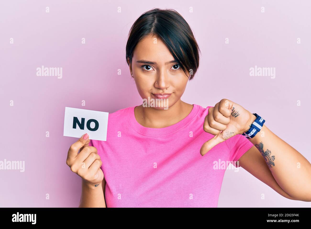 Beautiful young woman with short hair holding no word message with ...