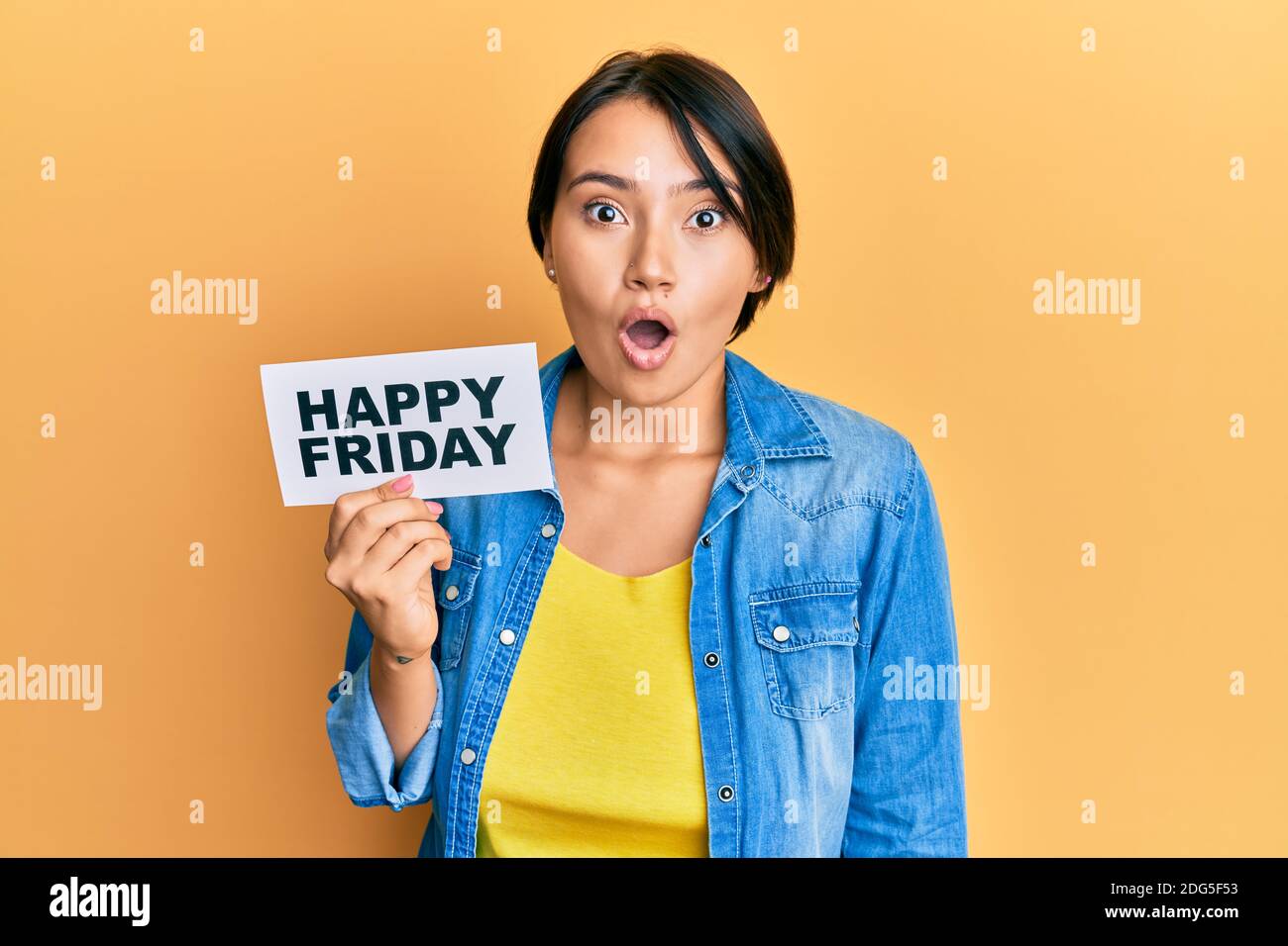 Beautiful young woman with short hair holding happy friday message ...