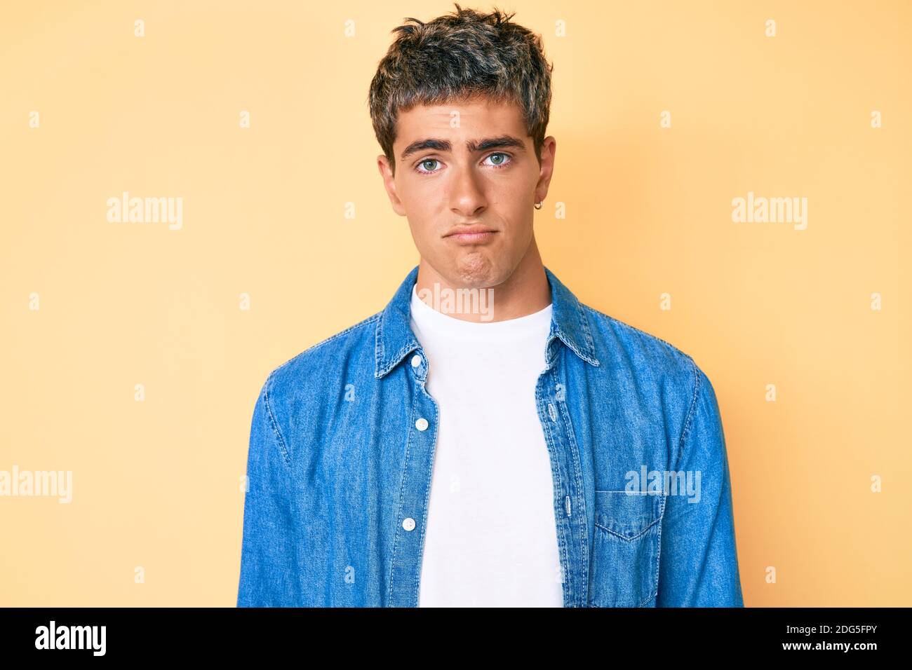 Young handsome man wearing casual clothes depressed and worry for ...