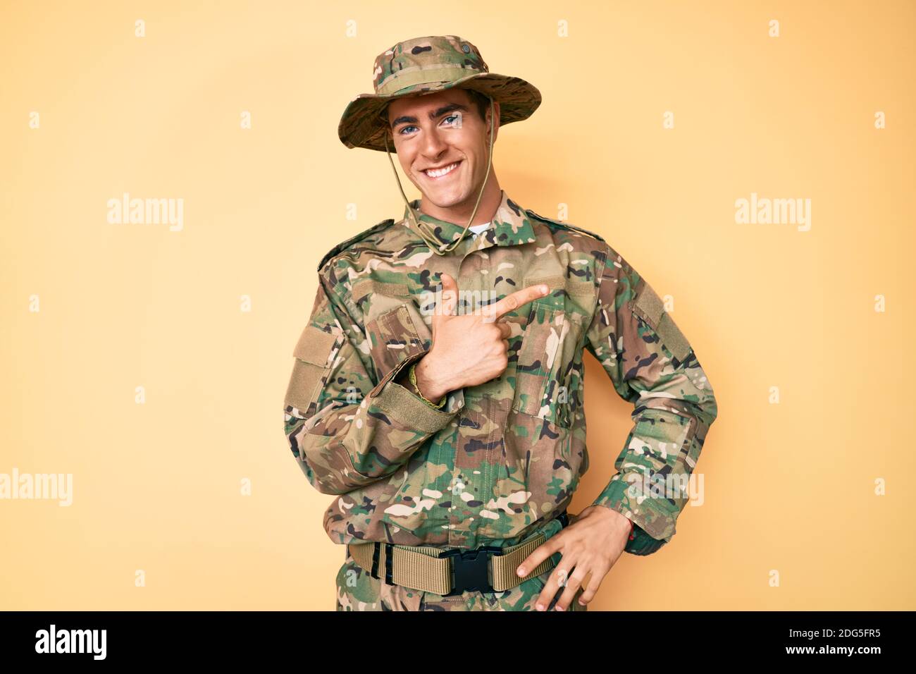 Young handsome man wearing camouflage army uniform cheerful with a ...