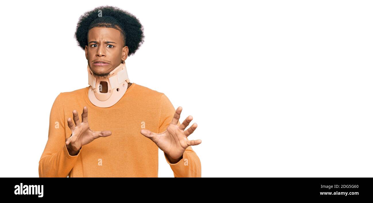 African american man with afro hair wearing cervical neck collar afraid ...