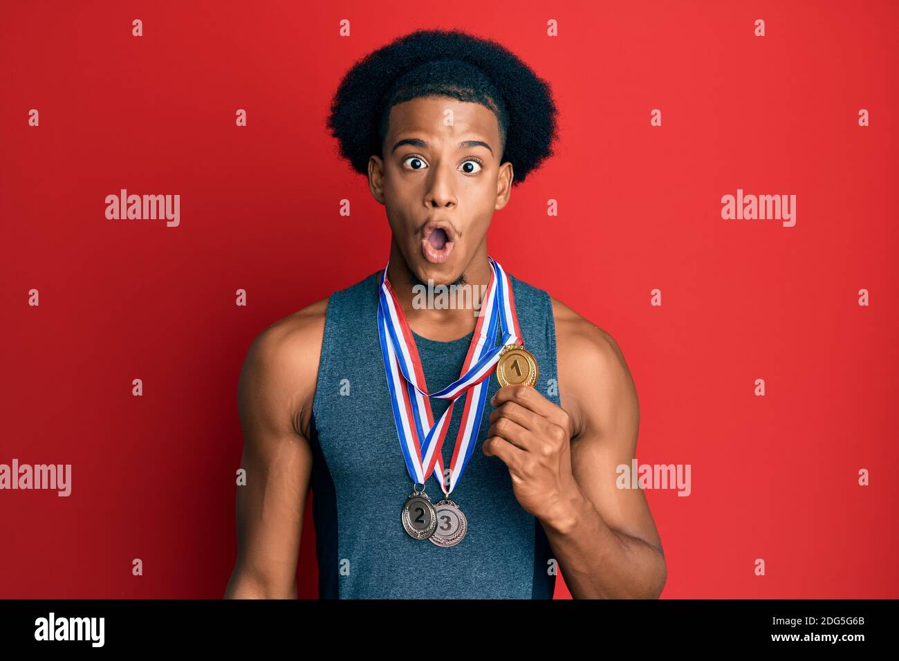 African american man with afro hair wearing winner medals scared and ...