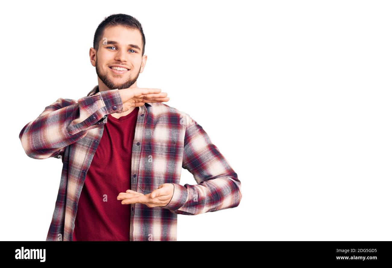 Young handsome man wearing casual shirt gesturing with hands showing ...