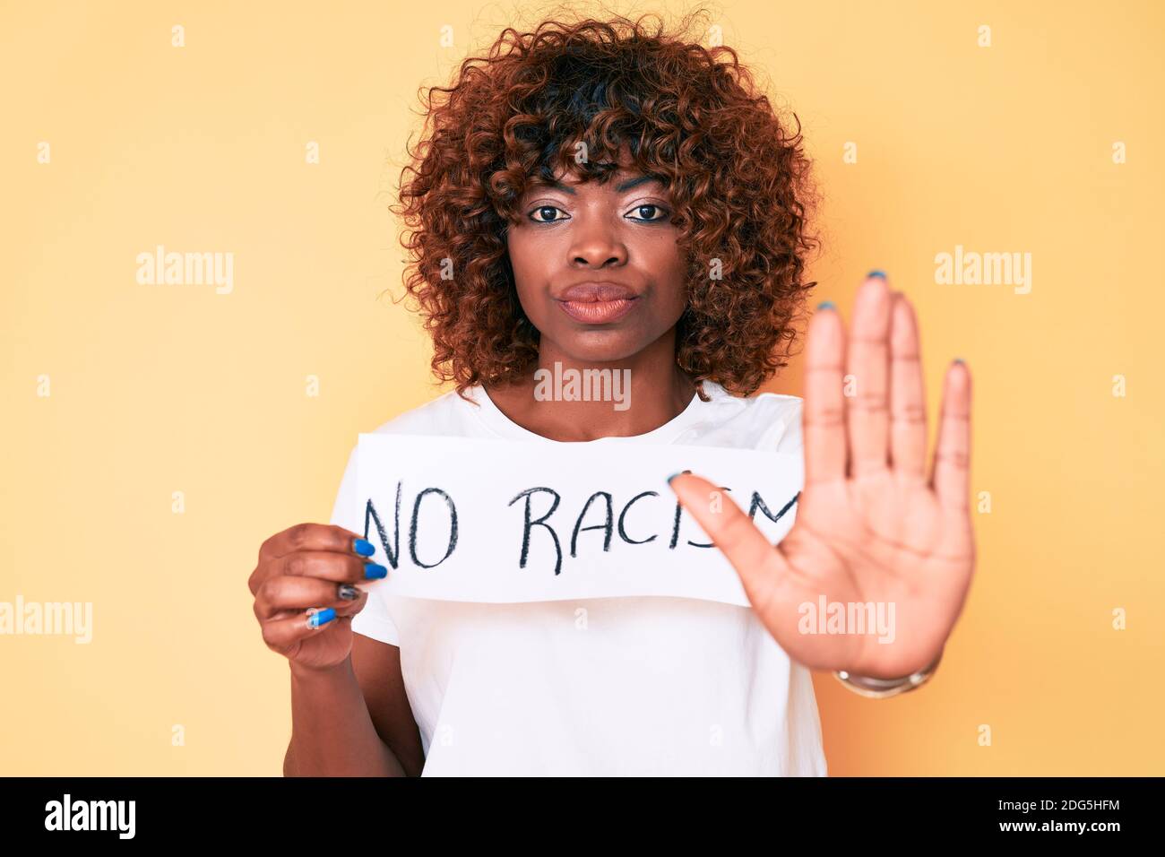 Young african american woman holding no racism banner with open hand ...