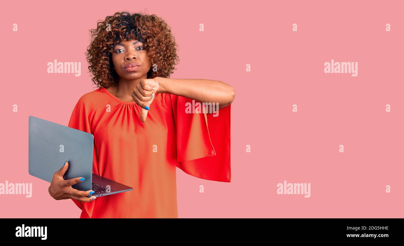 Young african american woman working using computer laptop with angry ...