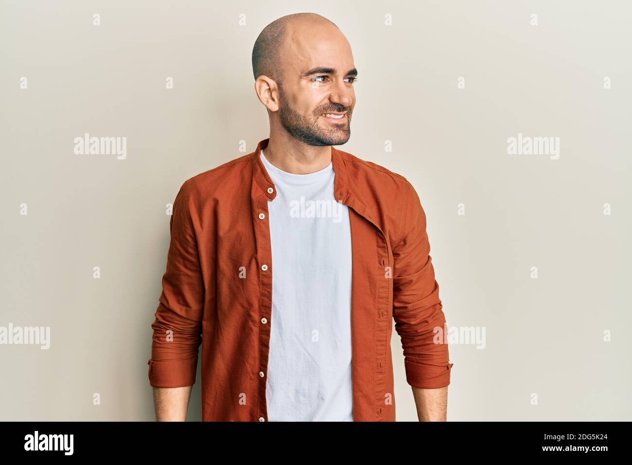 Young hispanic man wearing casual clothes looking to side, relax ...