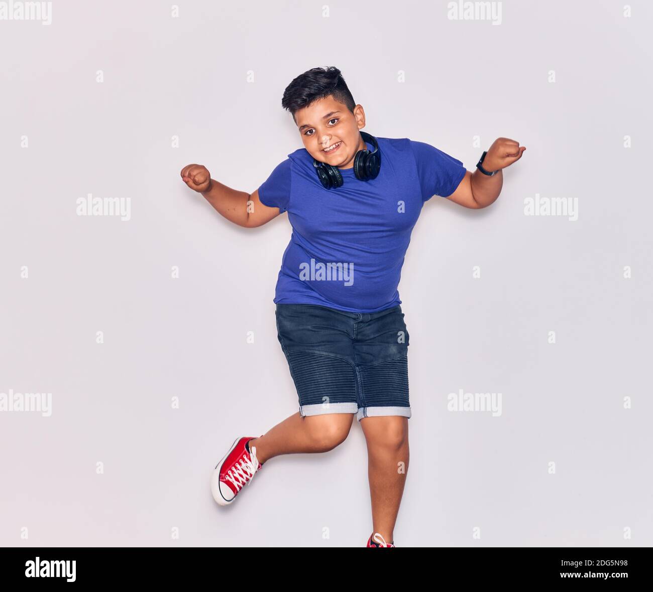 Adorable hispanic child boy smiling happy. Jumping with smile on face ...