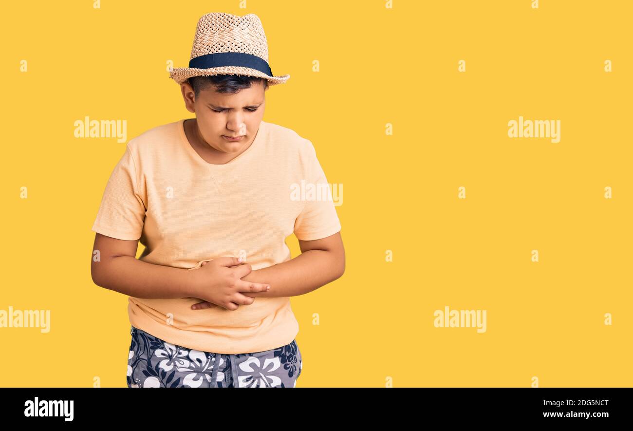 Little boy kid wearing summer hat and hawaiian swimsuit with hand on ...