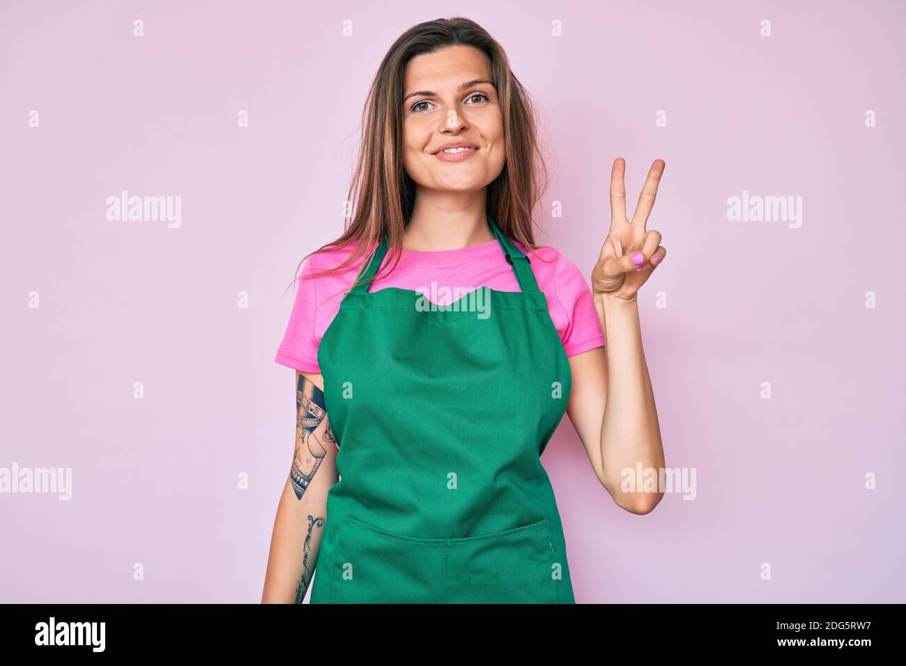 Beautiful caucasian woman wearing professional apron smiling with happy ...