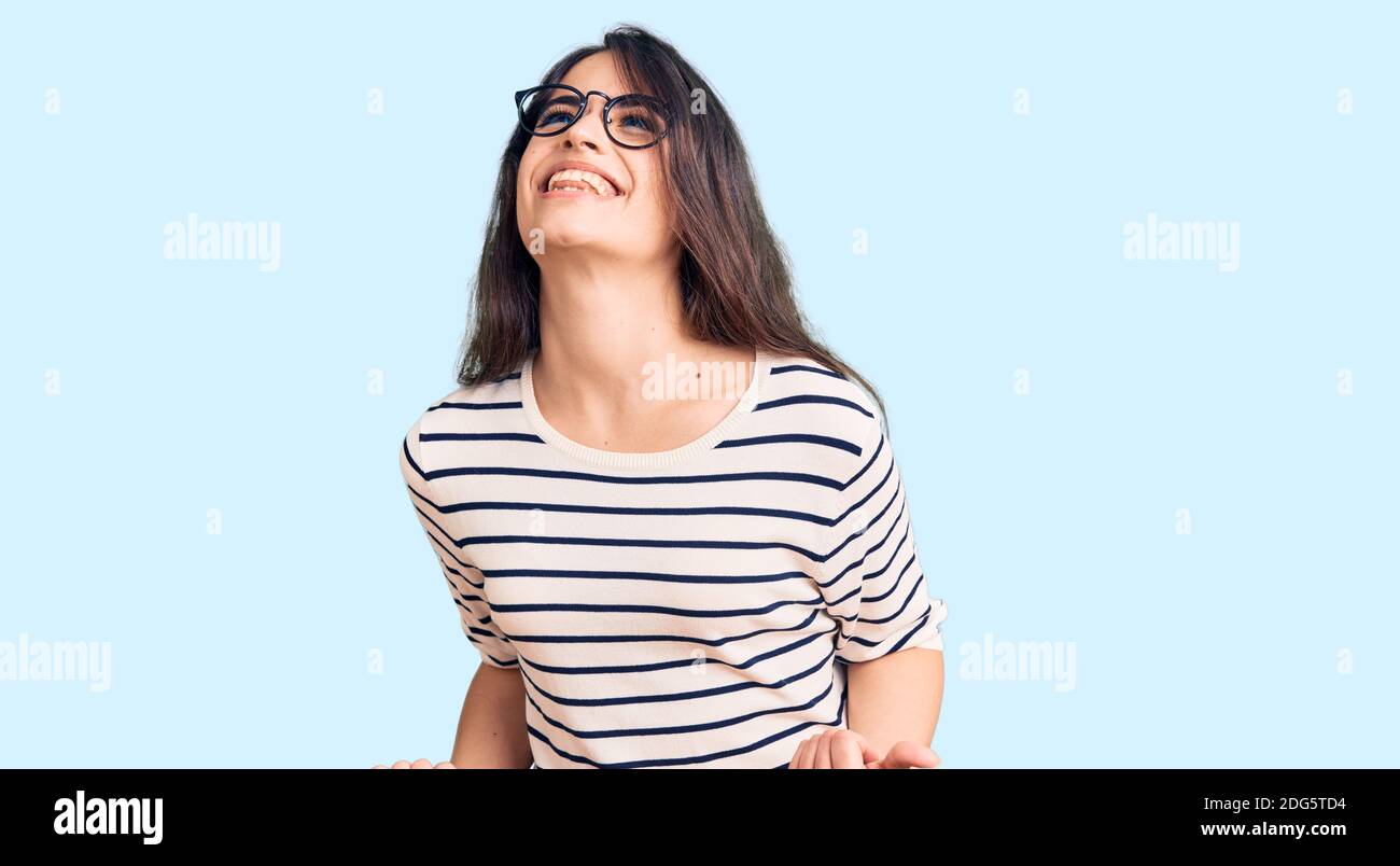 Brunette teenager girl wearing casual clothes and glasses very happy ...