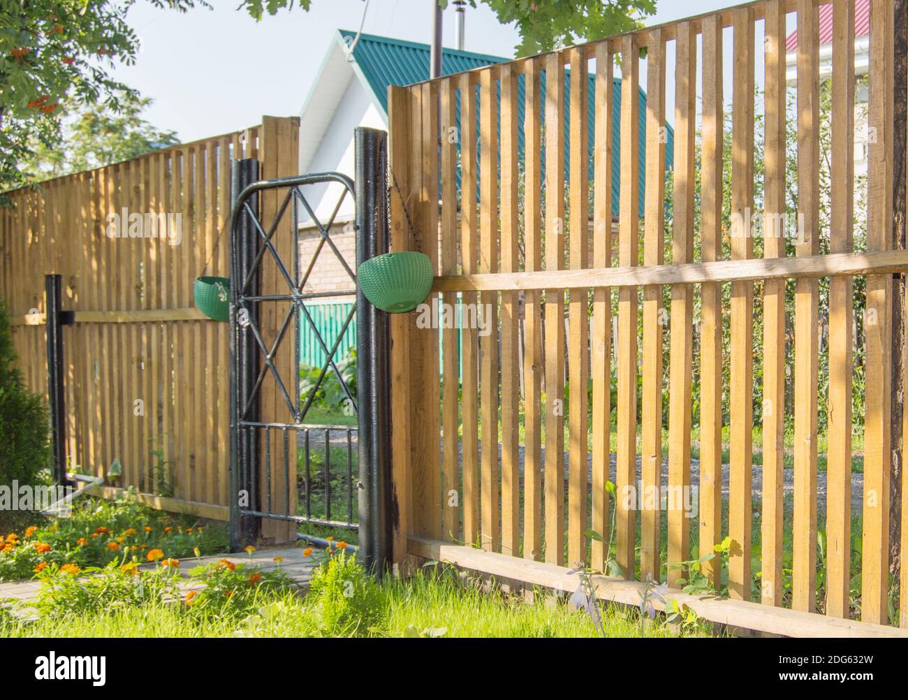 New wooden picket fence with metal gates, the concept of security and ...