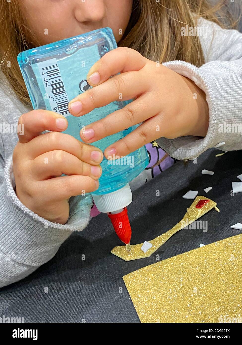 Close-up of girl's hands using the craft glue Stock Photo - Alamy