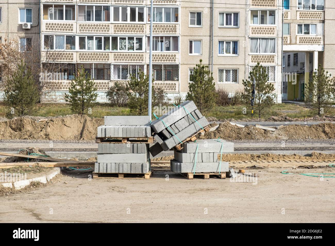 New concrete curbs in blocks on wooden pallets, road works ...
