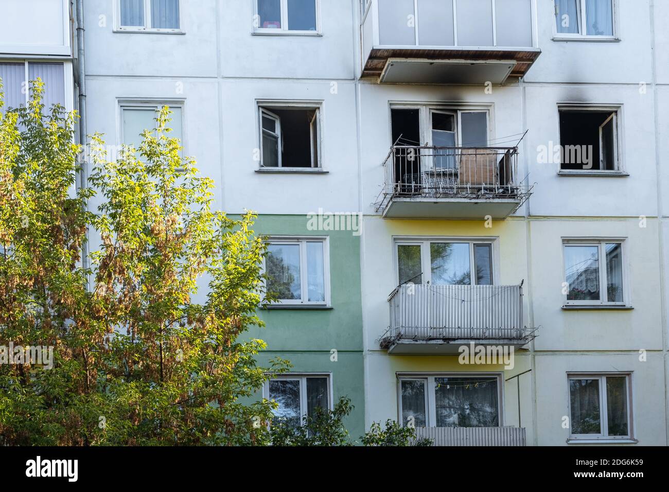 Fire in a residential, apartment building. Opened, broken windows of a ...