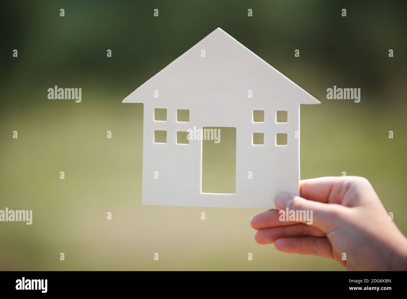 Hand holding house model outdoor Stock Photo - Alamy