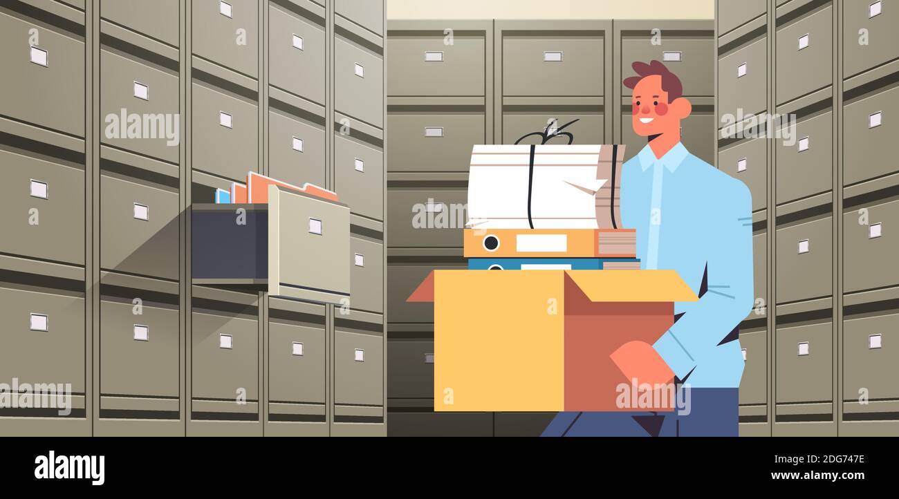 businessman holding cardboard box with documents in filing wall cabinet ...