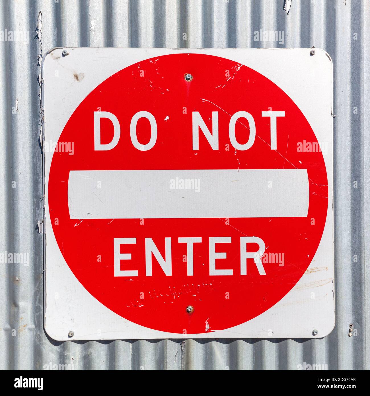 Do not enter sign on a corrugated iron wall Stock Photo - Alamy