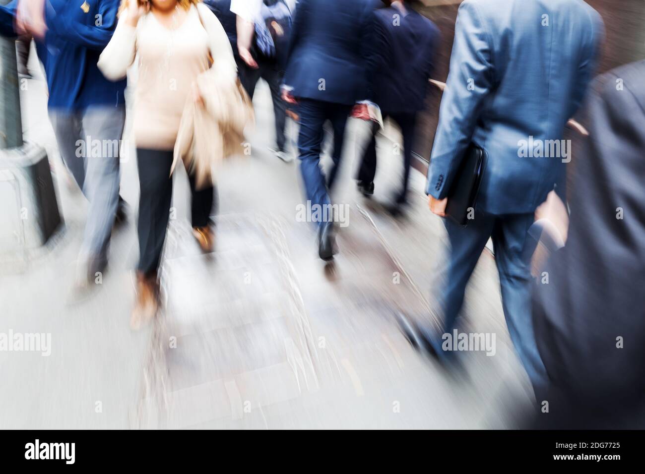 Picture with motion blur from business people on the move in the city ...