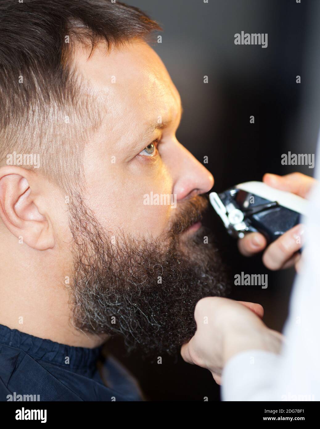 Man having his mustache trimmed at a barber Stock Photo - Alamy