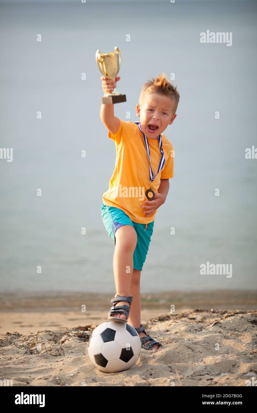 Football celebrating holding trophy hi-res stock photography and images - Alamy